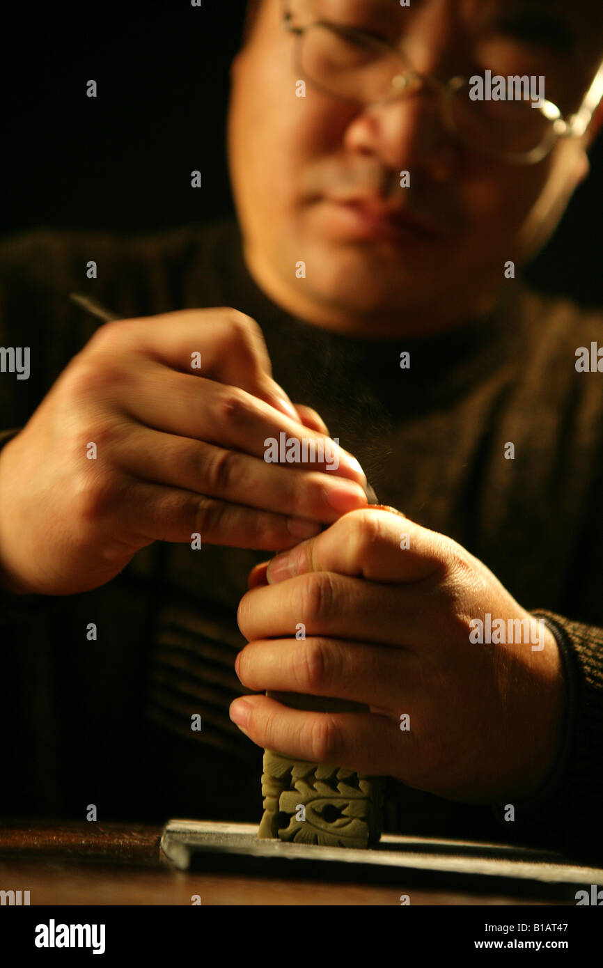 Chinese man carving chop Stock Photo - Alamy
