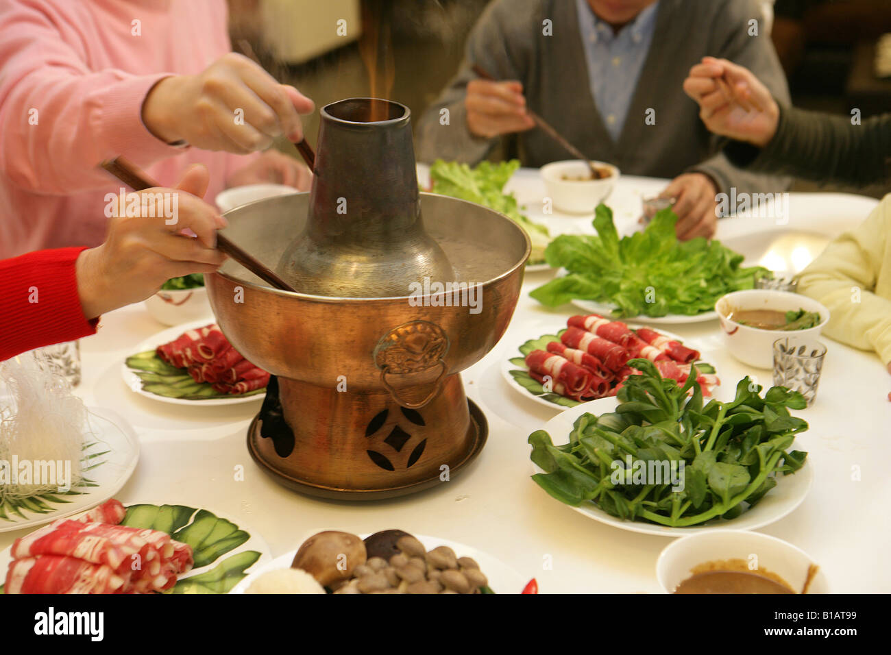 Chinese family at dinner table Stock Photo - Alamy