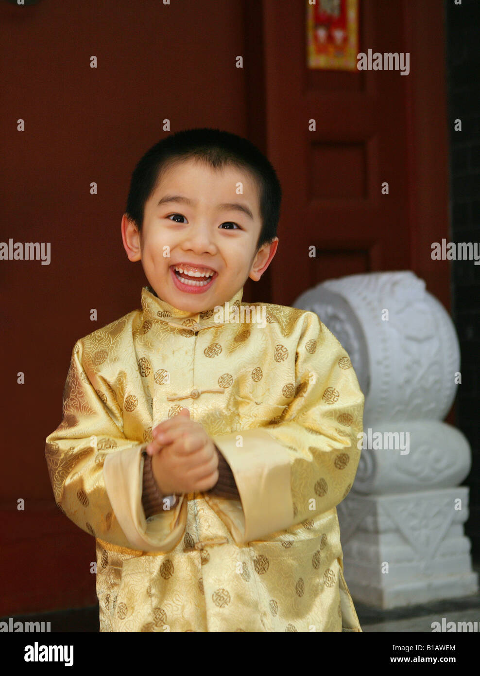 One chinese boy(4-5 years) standing in a Chinese traditional house gate ...