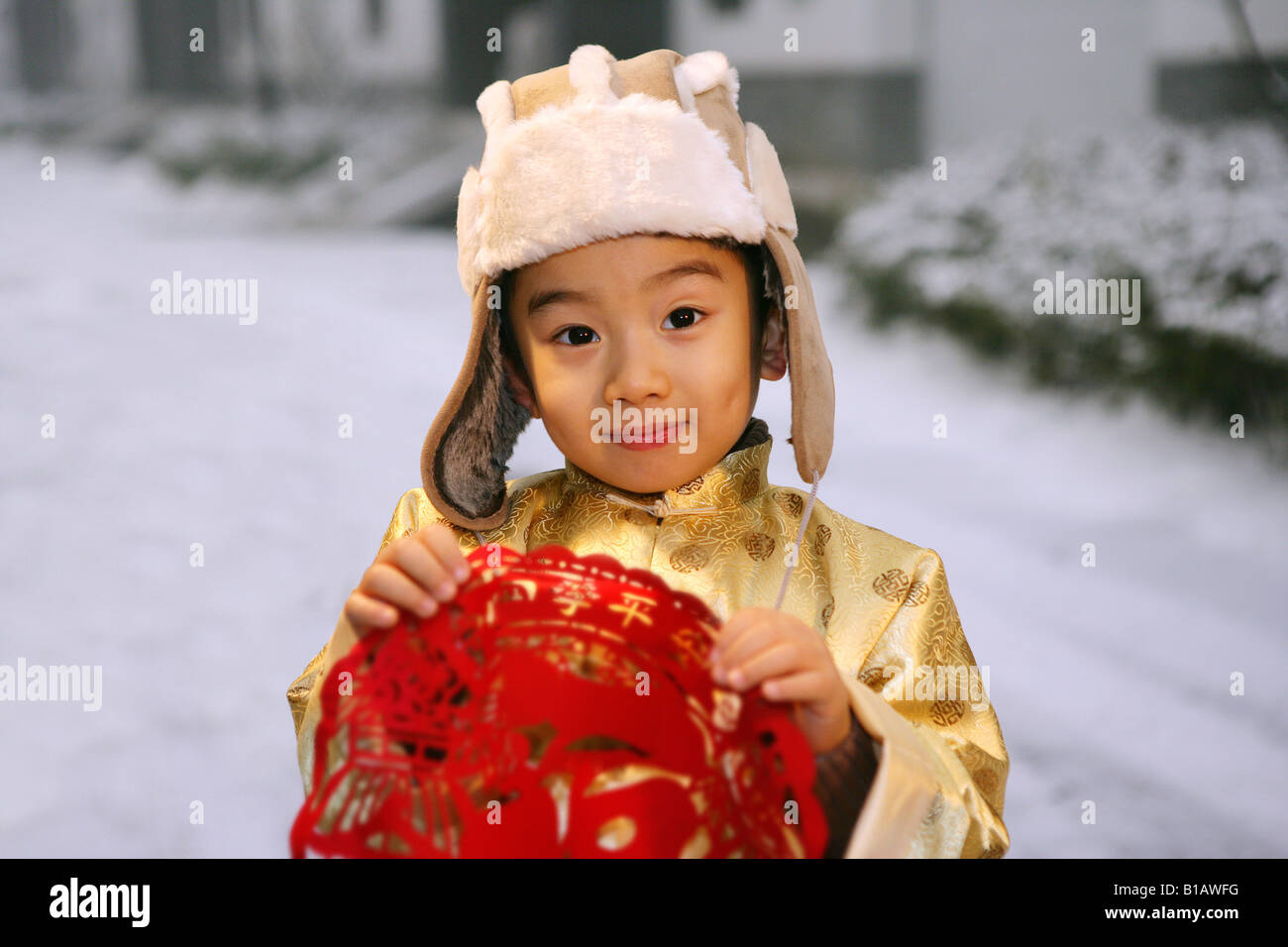 One chinese boy (4-5 years) standing in front of a Chinese traditional ...