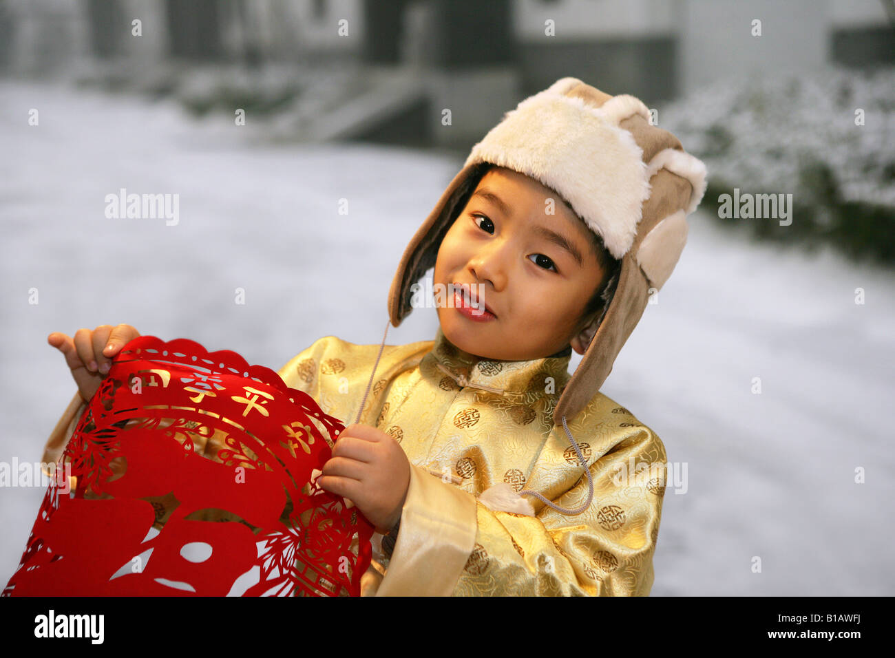 One chinese boy (4-5 years) standing in front of a Chinese traditional ...