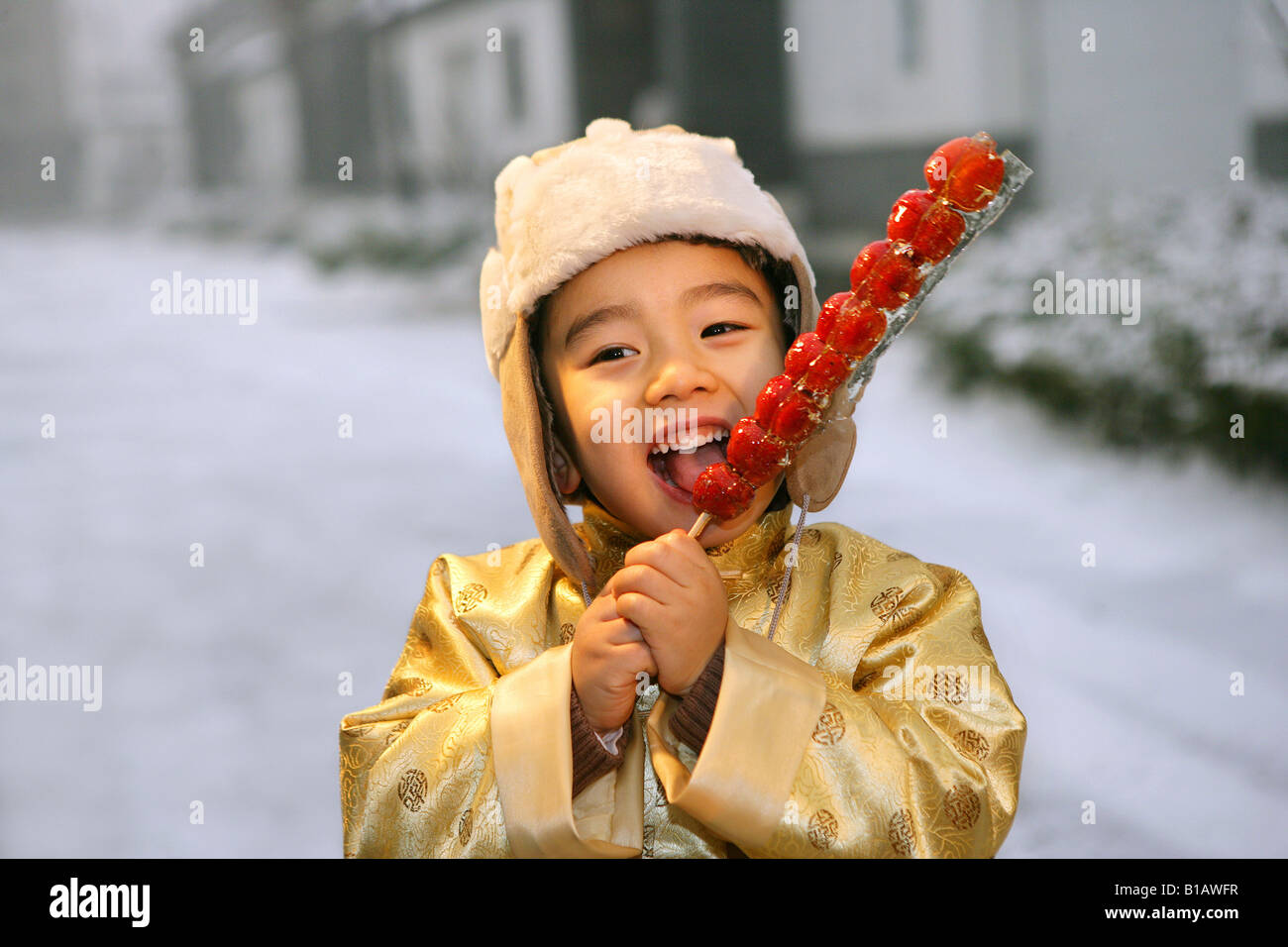 One chinese boy (4-5 years) standing in front of a Chinese traditional ...