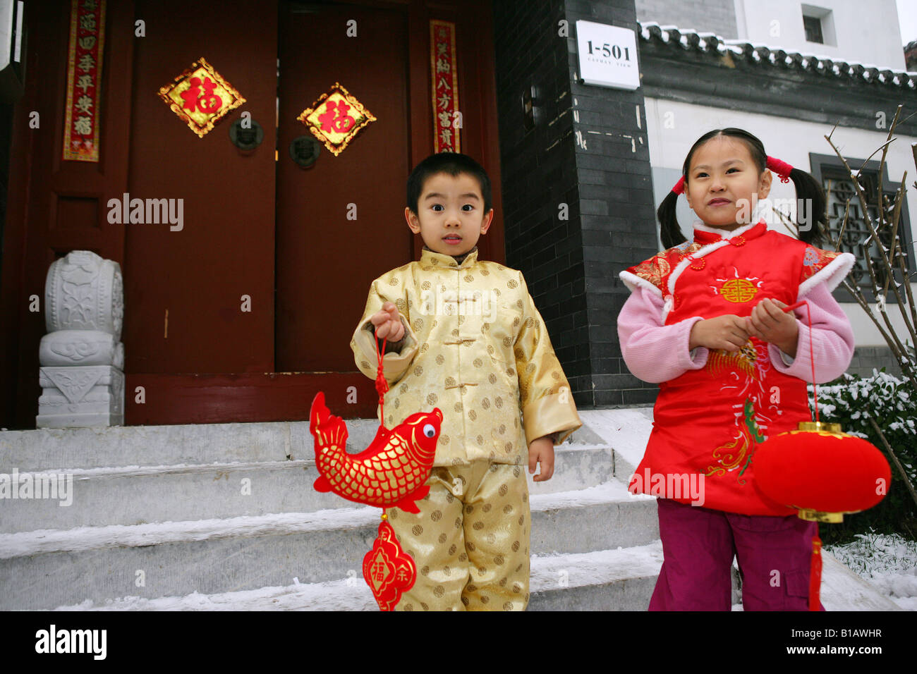 Two children(5-7 years) standing in front of chinese traditional house ...