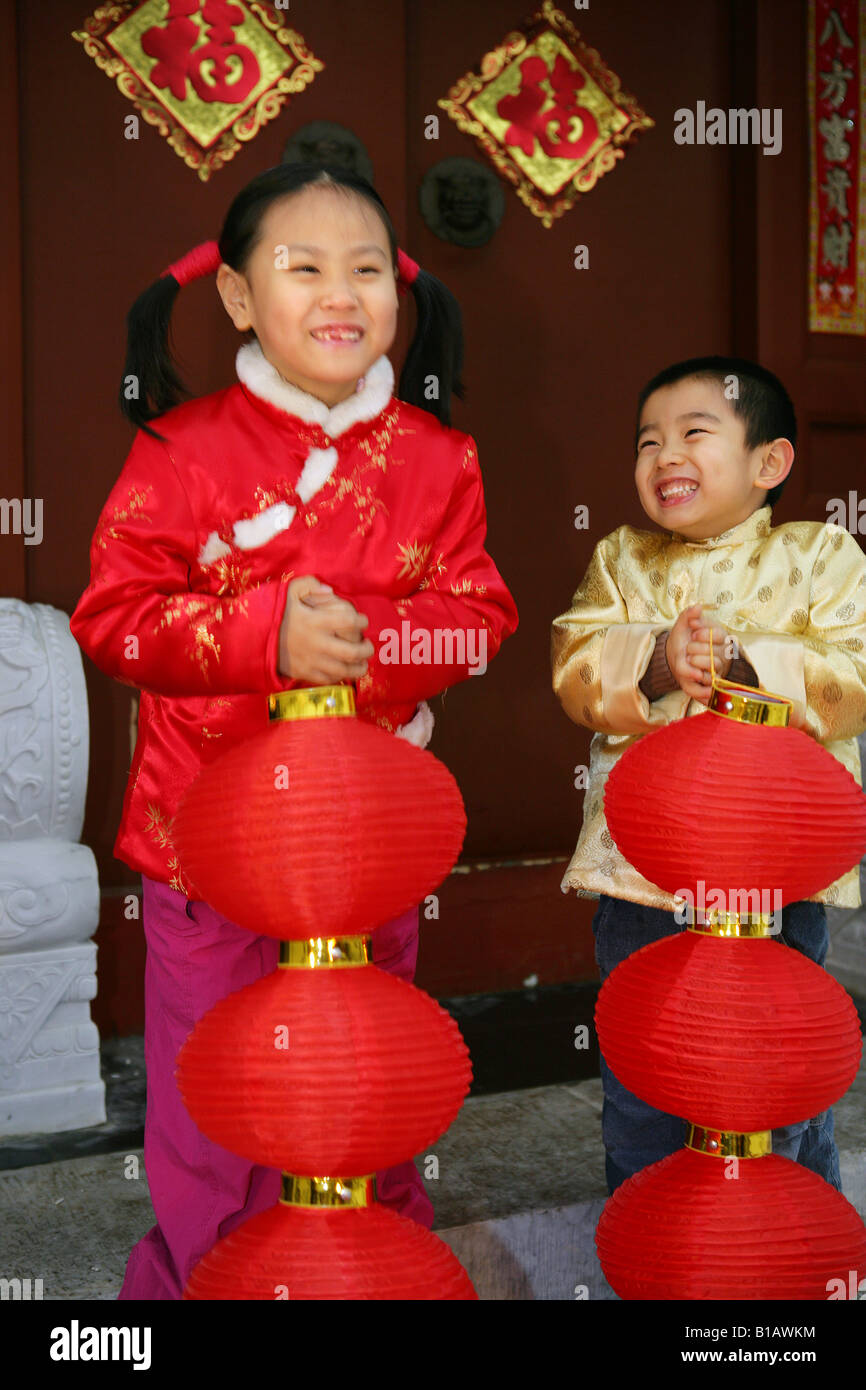 Two children(5-7 years) standing in front of chinese traditional house ...