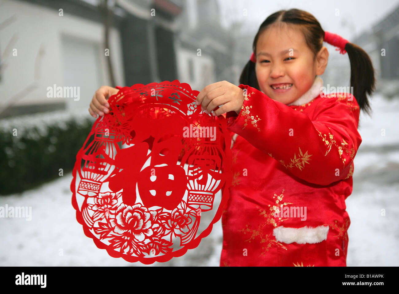 one chinese girl holding a paper cut smiling Stock Photo - Alamy