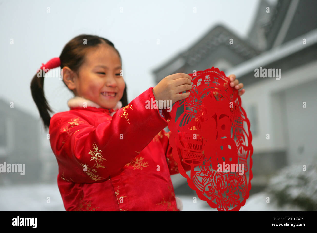 one chinese girl holding a paper cut smiling Stock Photo - Alamy