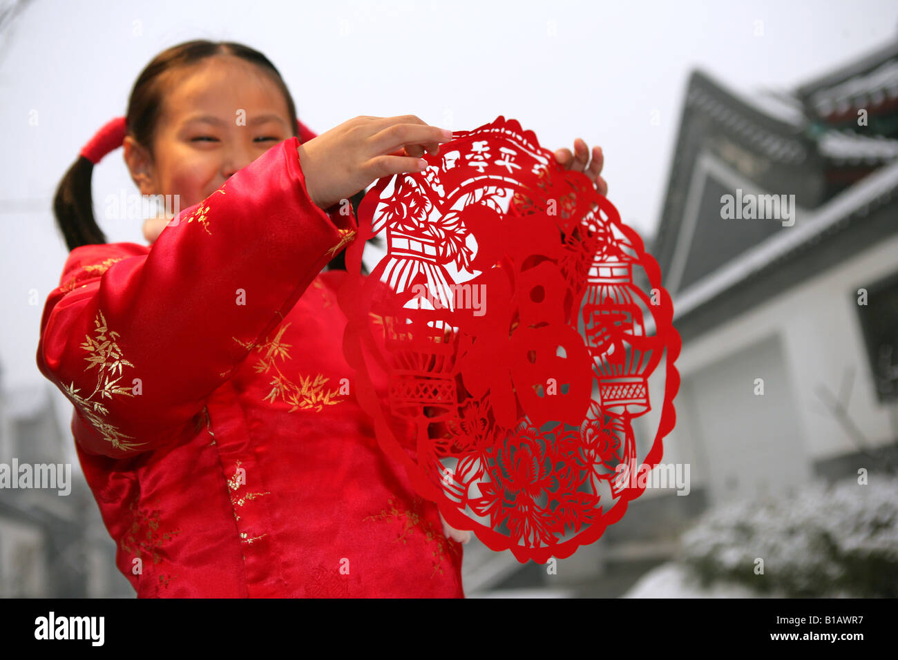 one chinese girl holding a paper cut smiling Stock Photo - Alamy
