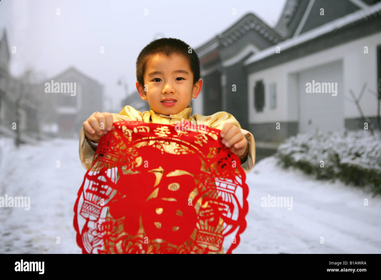 one chinese boy holding a paper cut smiling Stock Photo - Alamy
