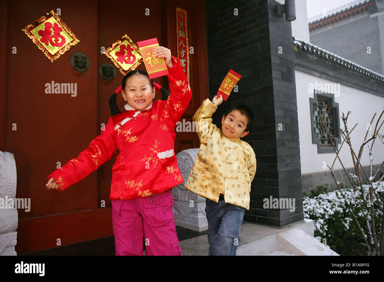 Two children(5-7 years) standing in front of chinese traditional house ...