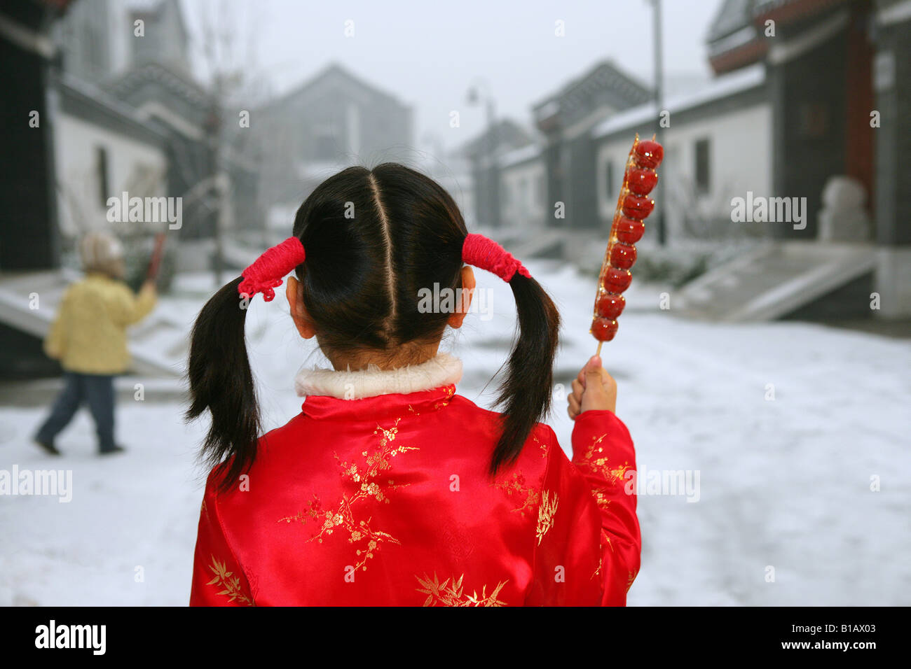 back of two chinese children standing in front of traditional chinese ...