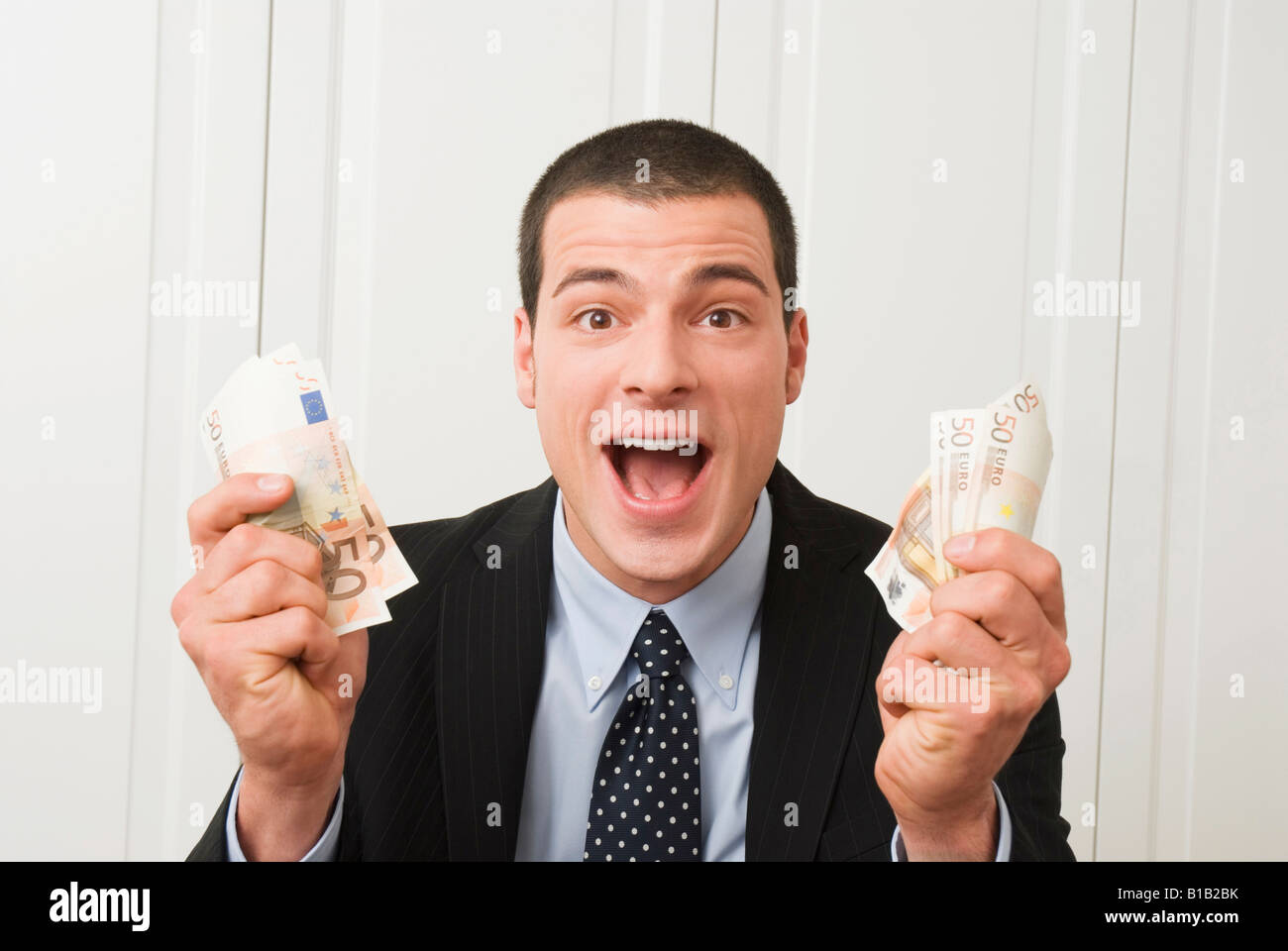 Young man holding euro banknotes, portrait Stock Photo - Alamy