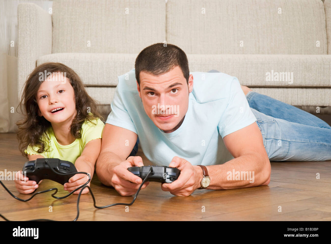 Father and daughter (8-9) playing computer game Stock Photo - Alamy