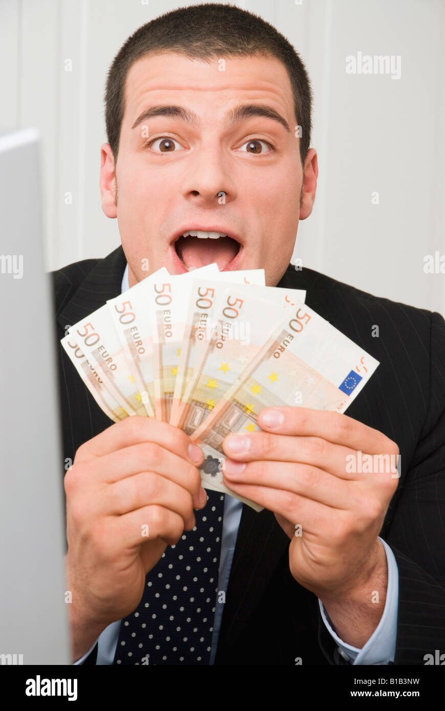Young man holding euro banknotes, portrait Stock Photo - Alamy