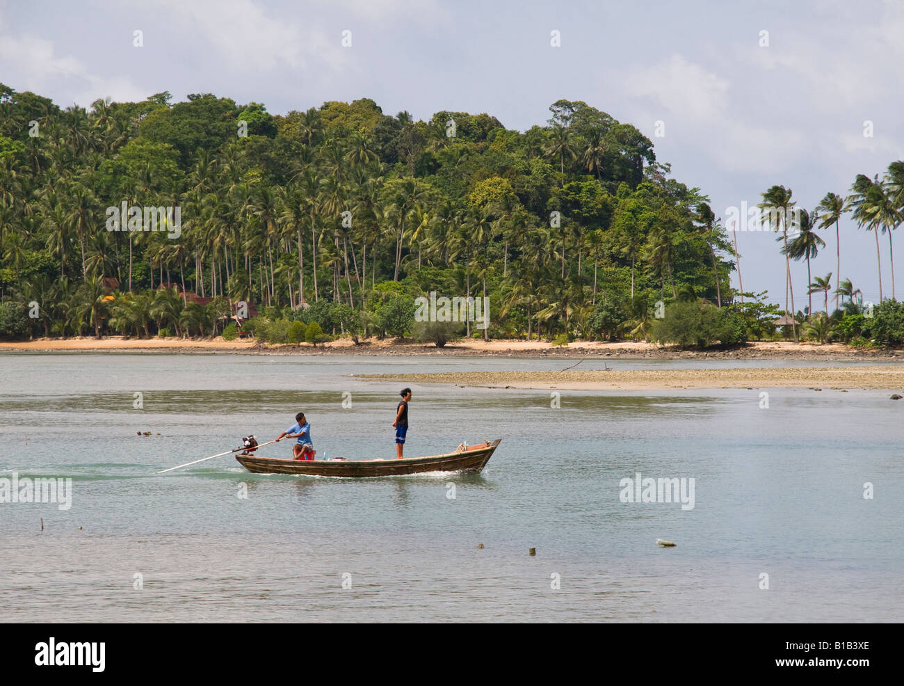 Thailand Trat province Koh Chang Island two men riding on small boat ...