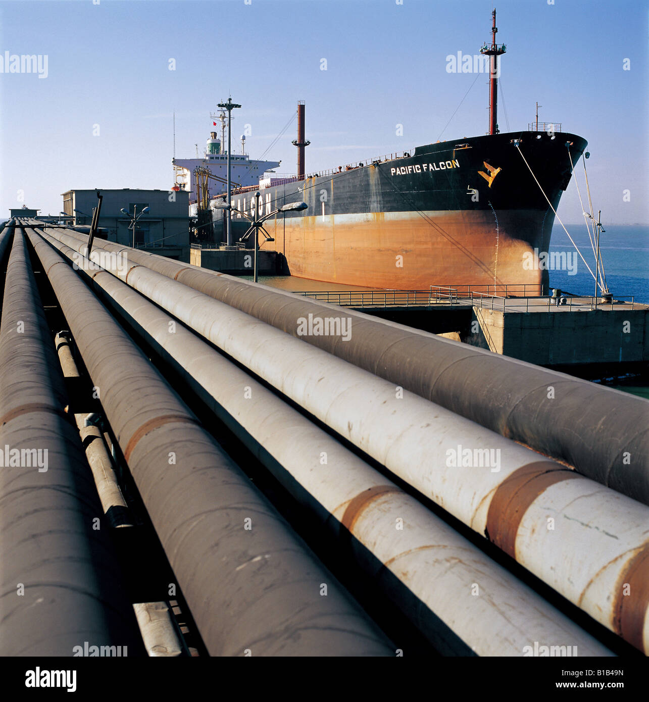 container ship and pipes at marina Stock Photo - Alamy