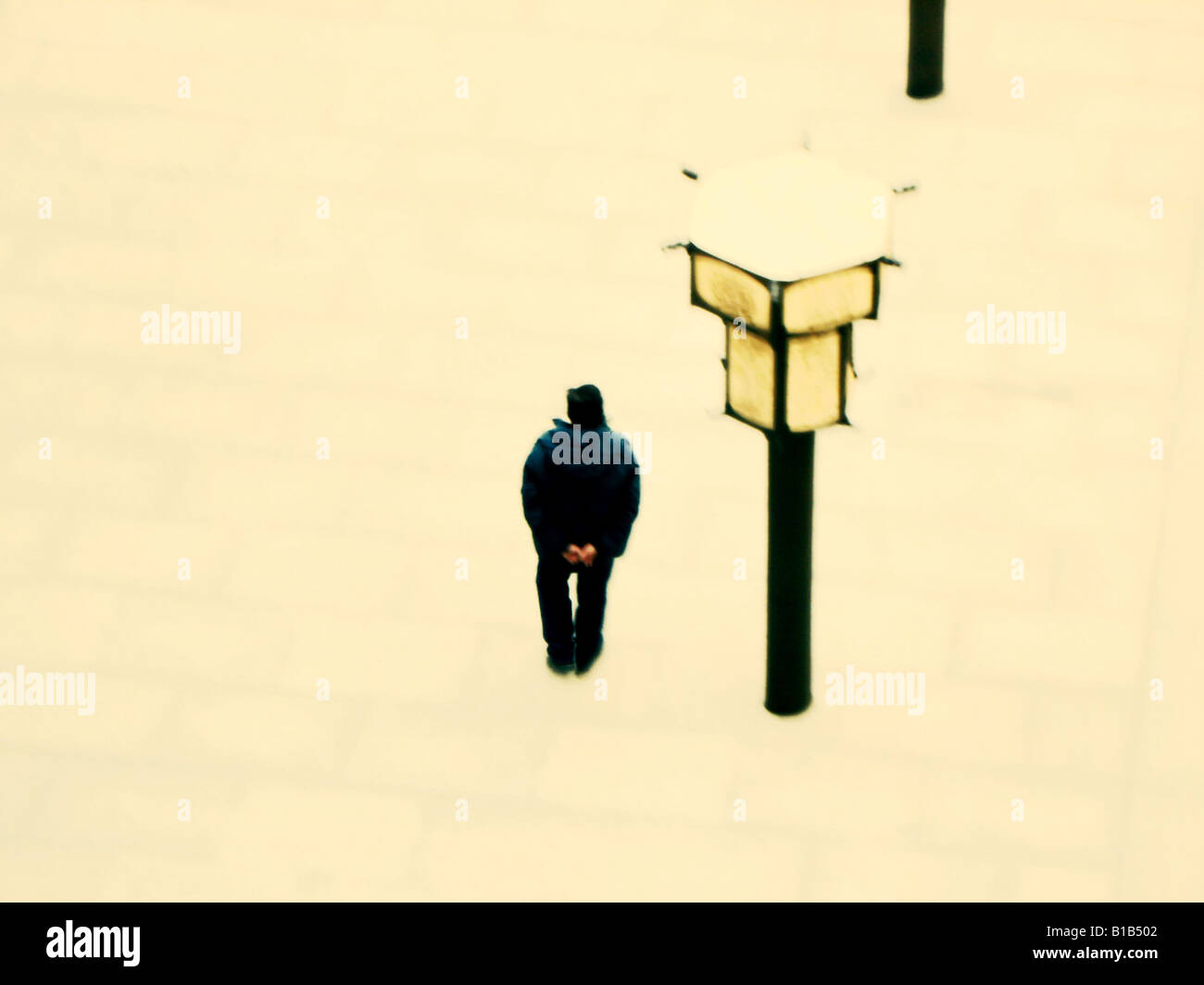 man standing alone beside a lamp Stock Photo - Alamy