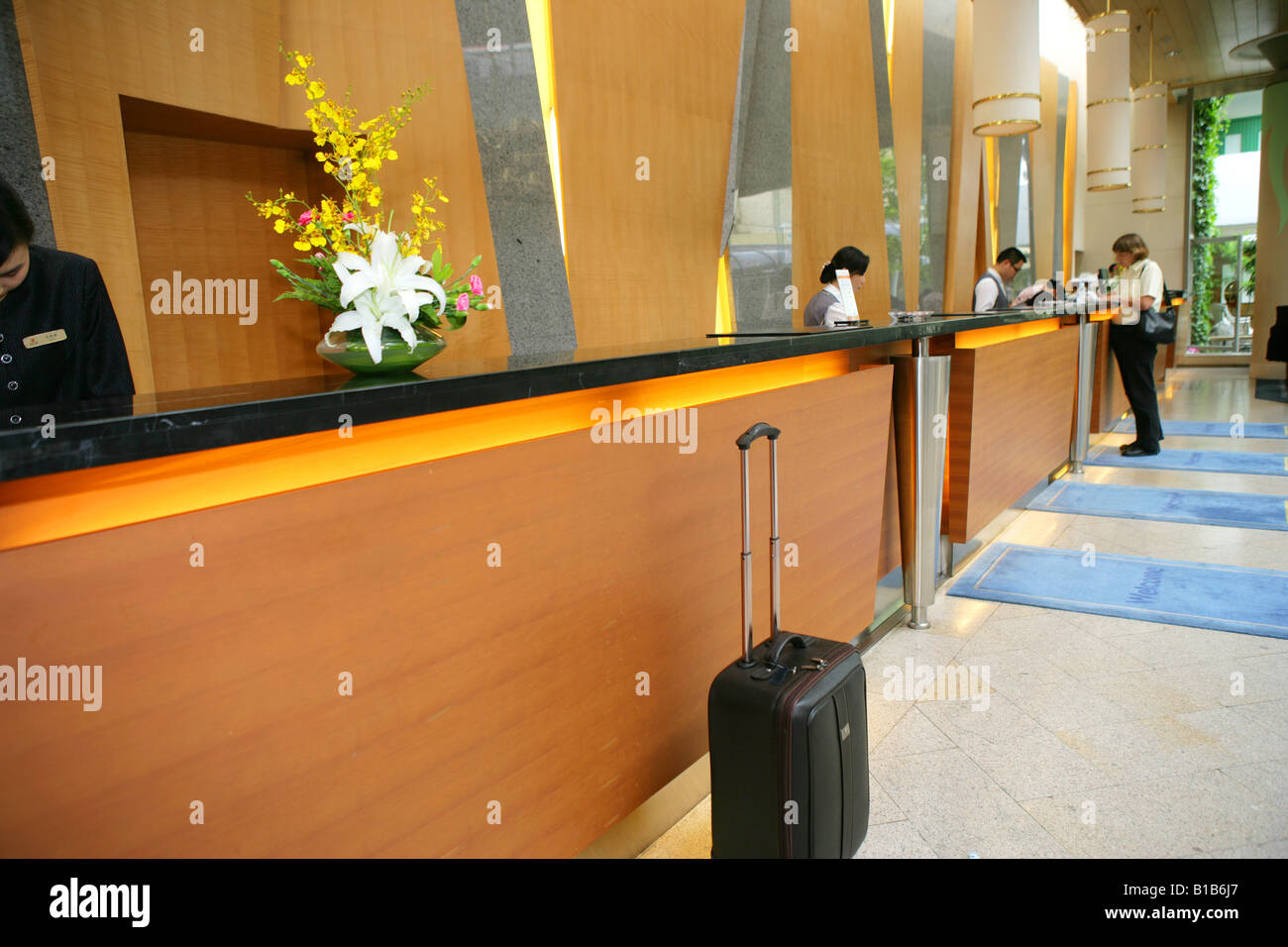 hotel reception and a suitcase Stock Photo - Alamy