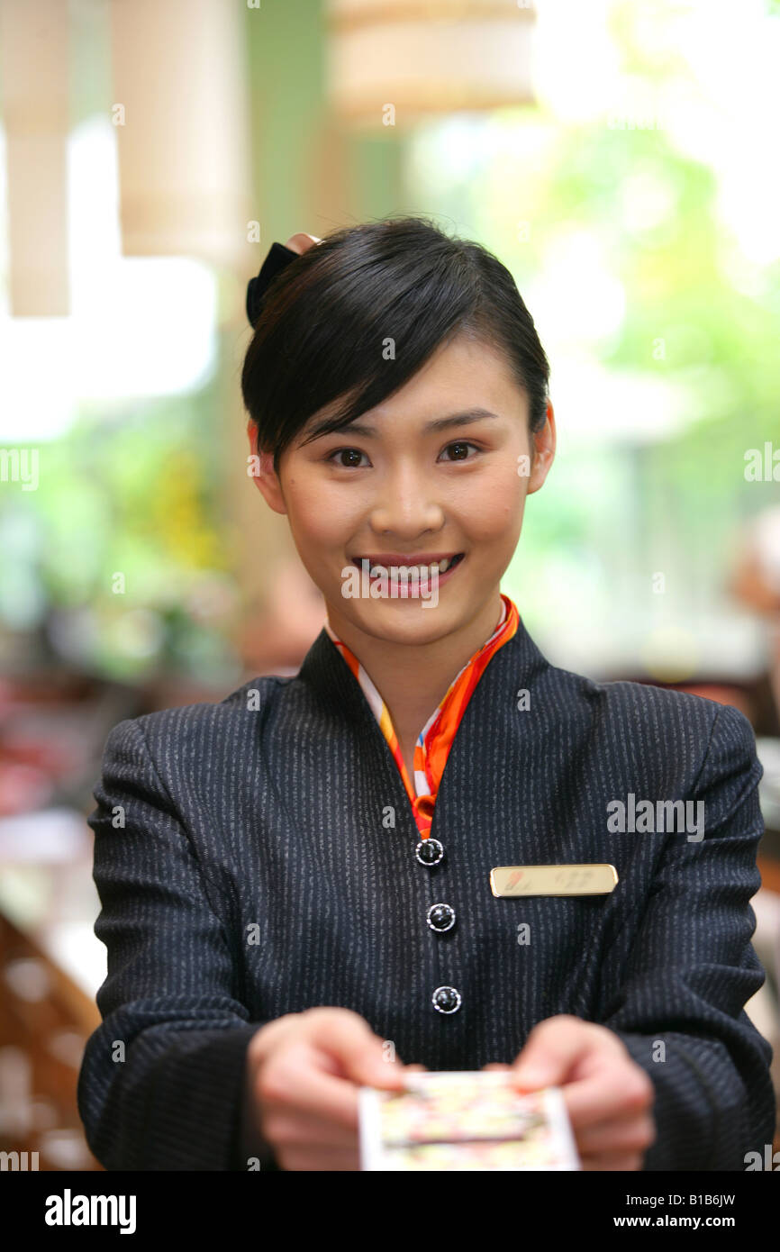 hotel receptionist passing business card Stock Photo - Alamy