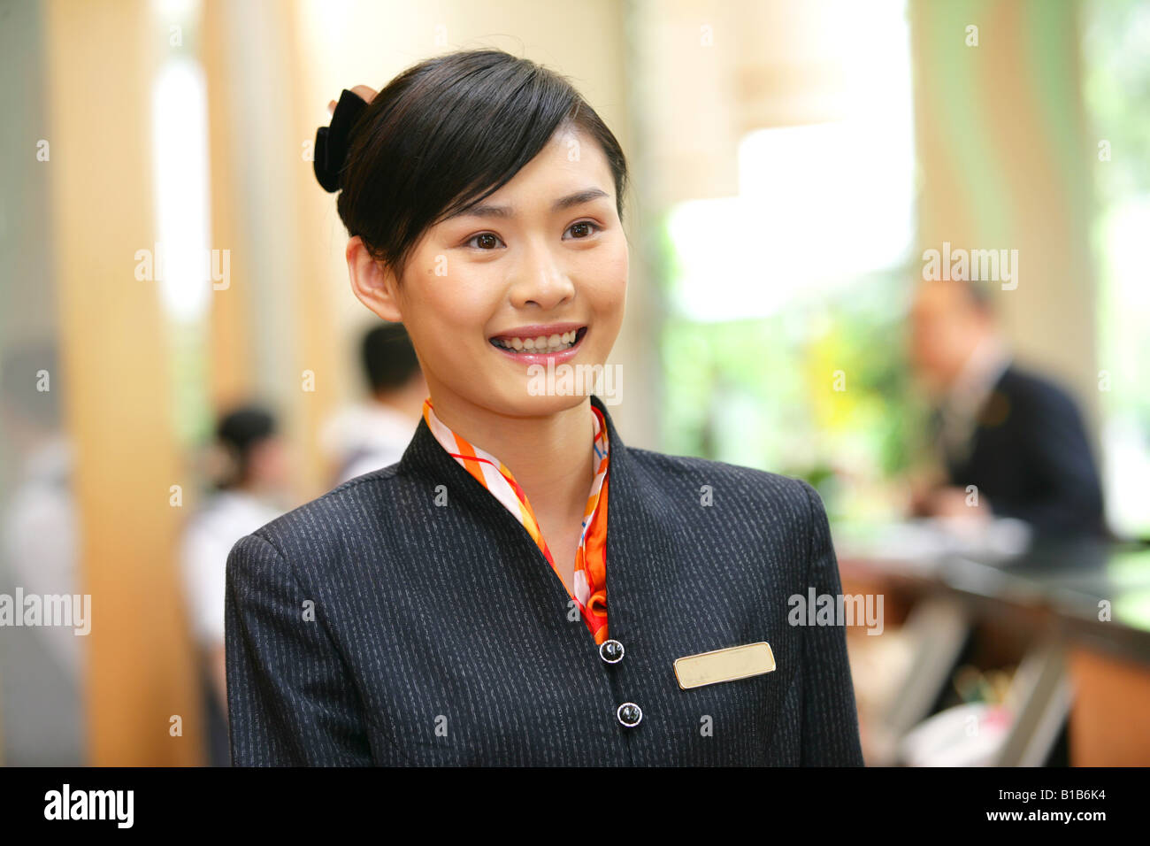 Portrait female hotel receptionist standing hi-res stock photography ...