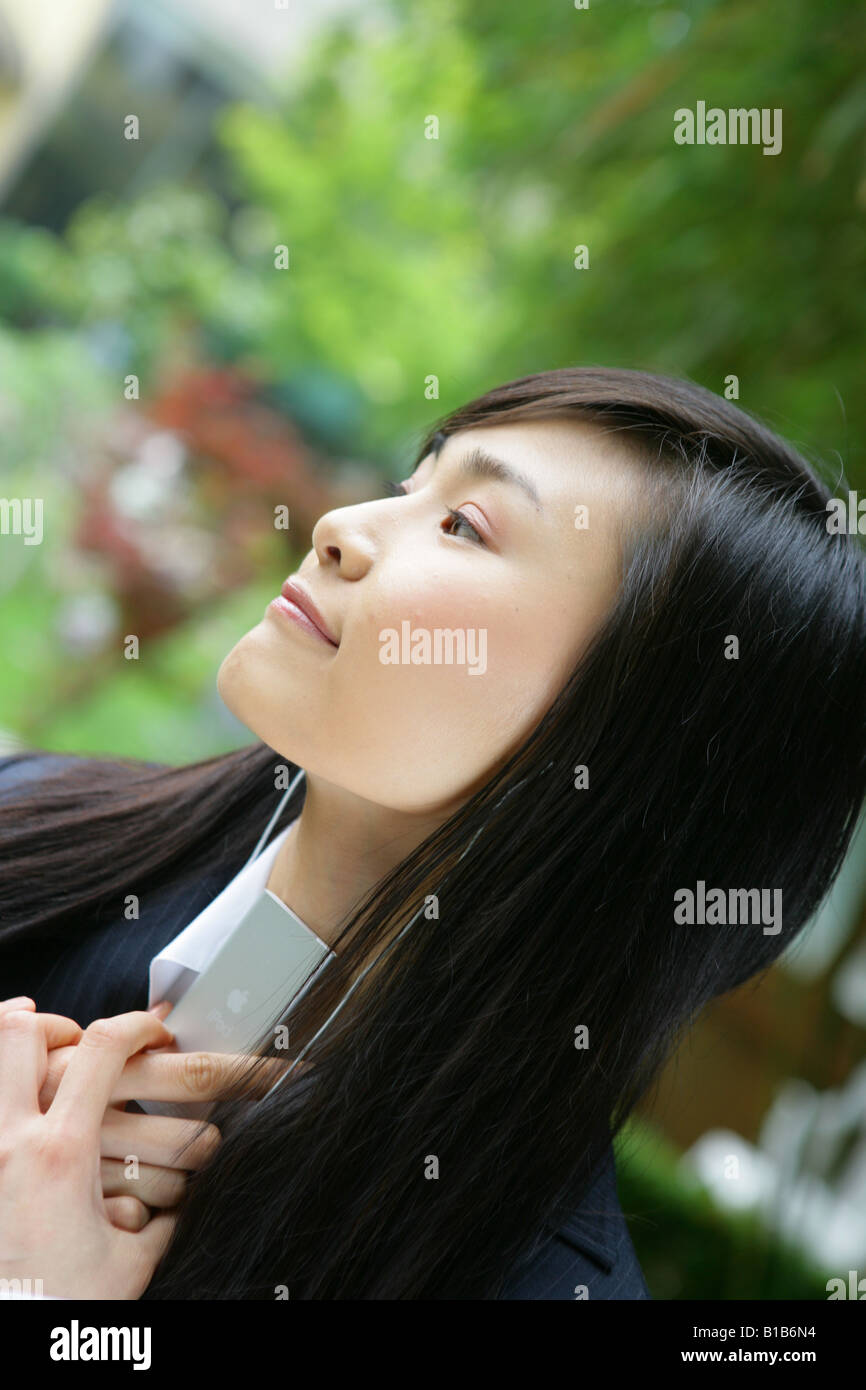 portrait of businesswoman listening music with MP3 Stock Photo - Alamy