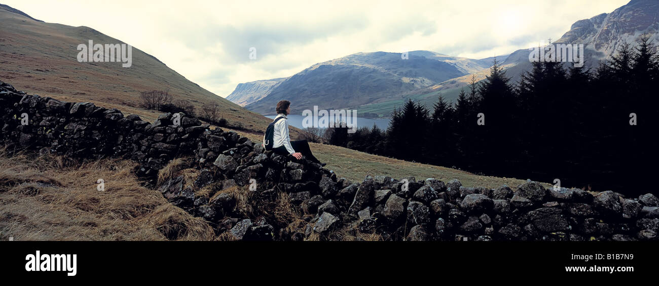 Hiker contemplating stunning mountain & lake view Stock Photo - Alamy