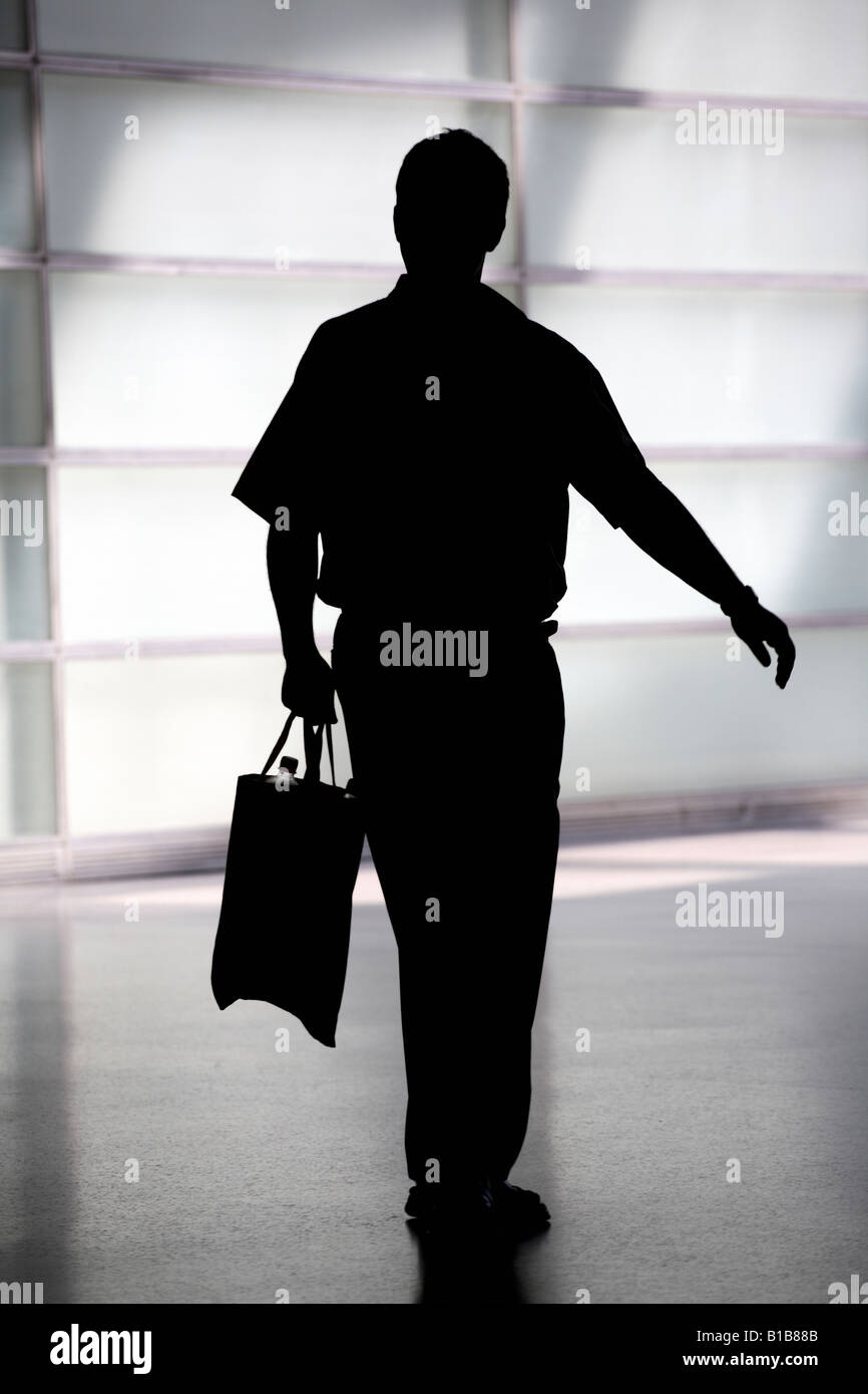 Silhouette of a man with a bag Stock Photo - Alamy