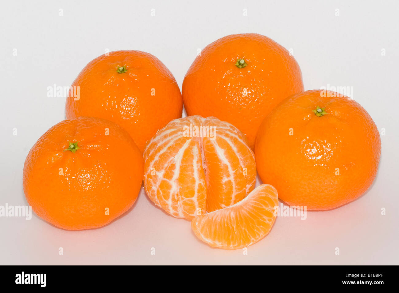 Five Clementines, an one peeled Stock Photo - Alamy