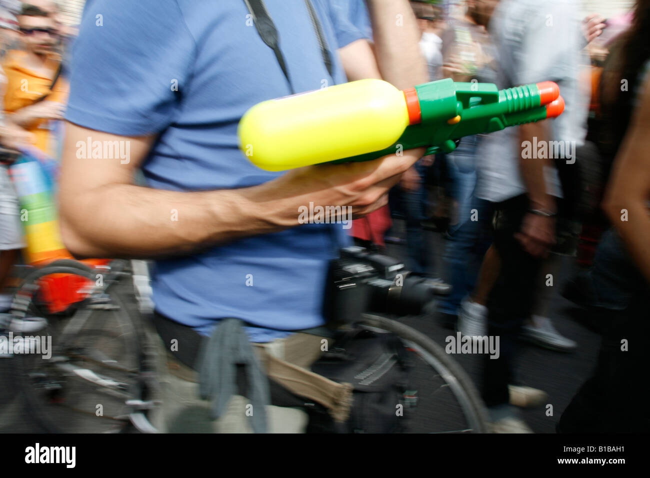 man with water pistol gun in street road in city town Stock Photo - Alamy