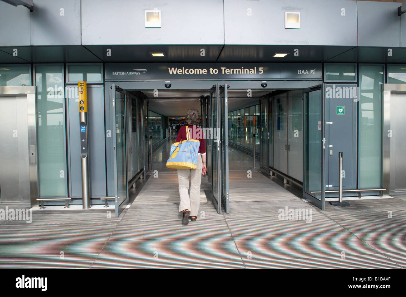 Welcome to Heathrow Terminal 5 - lady walking through entrance Stock ...