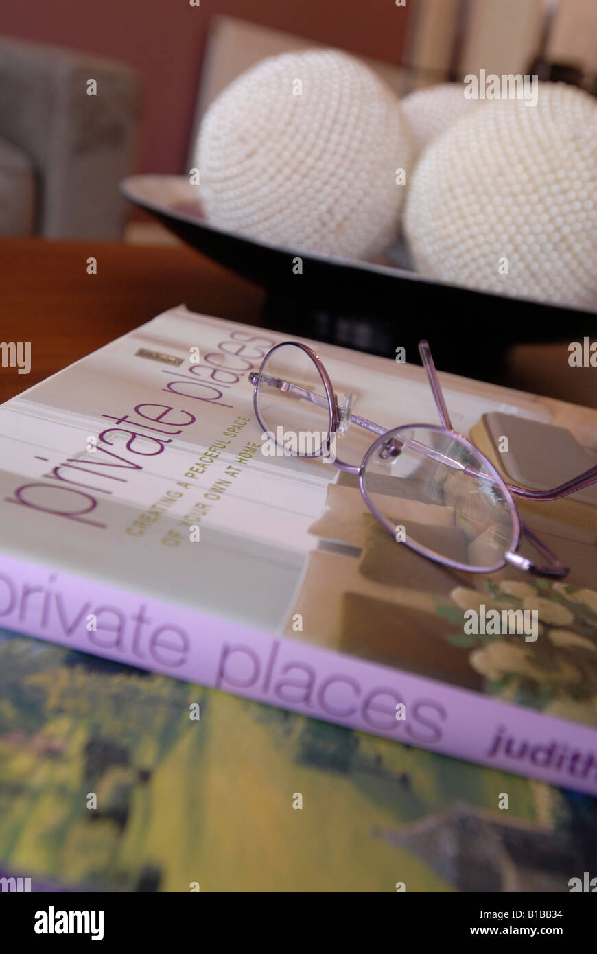Books and reading glasses on a coffee table Stock Photo - Alamy