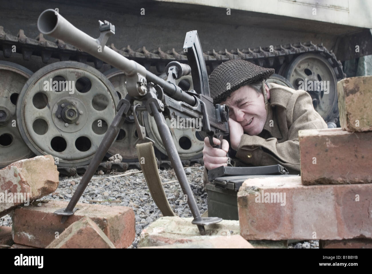 British Second World War Soldier firing machine gun next to tank Stock ...