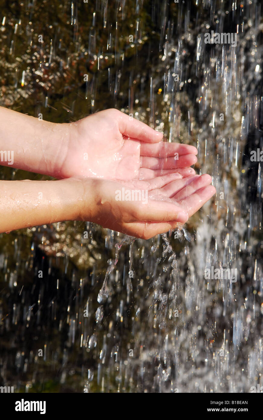 Child catching falling water with her hands Environmental concept Stock ...