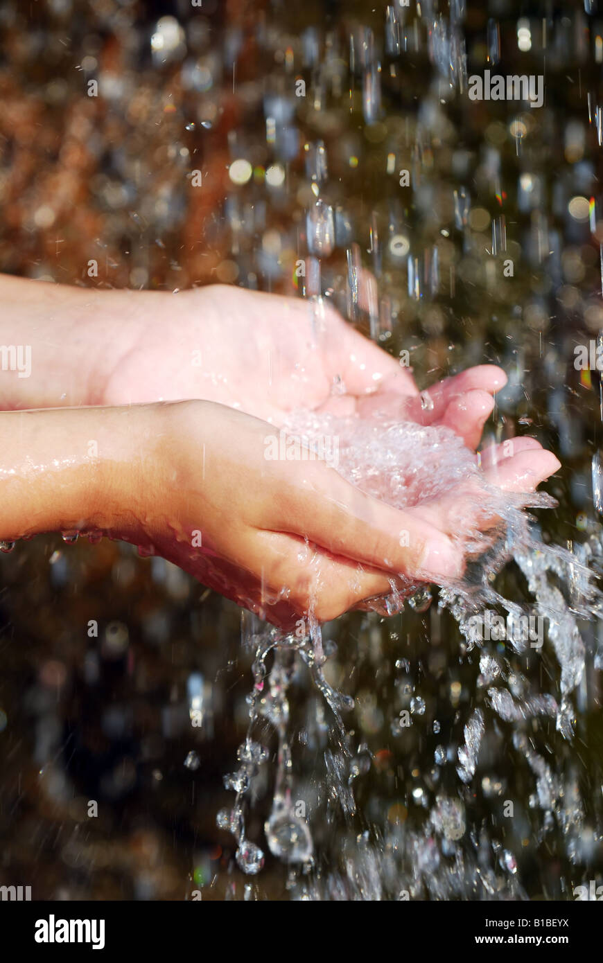 Child catching falling water with her hands Environmental concept Stock ...