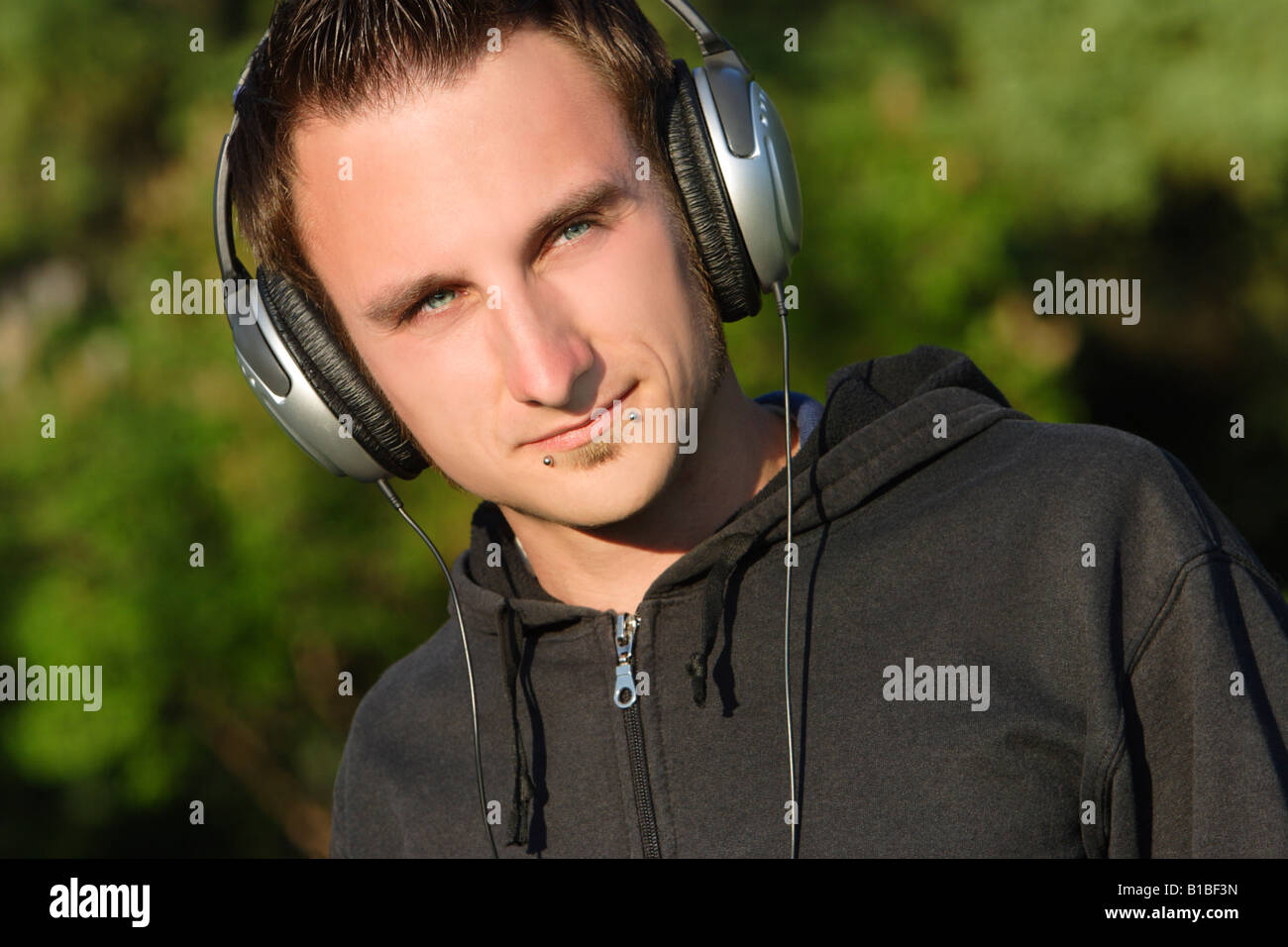 Man listening through headphones Stock Photo - Alamy