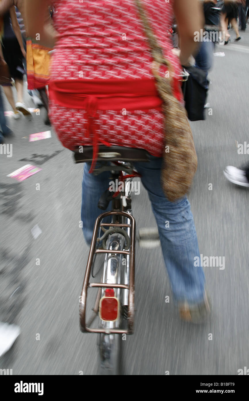woman riding bike on street in town Stock Photo - Alamy
