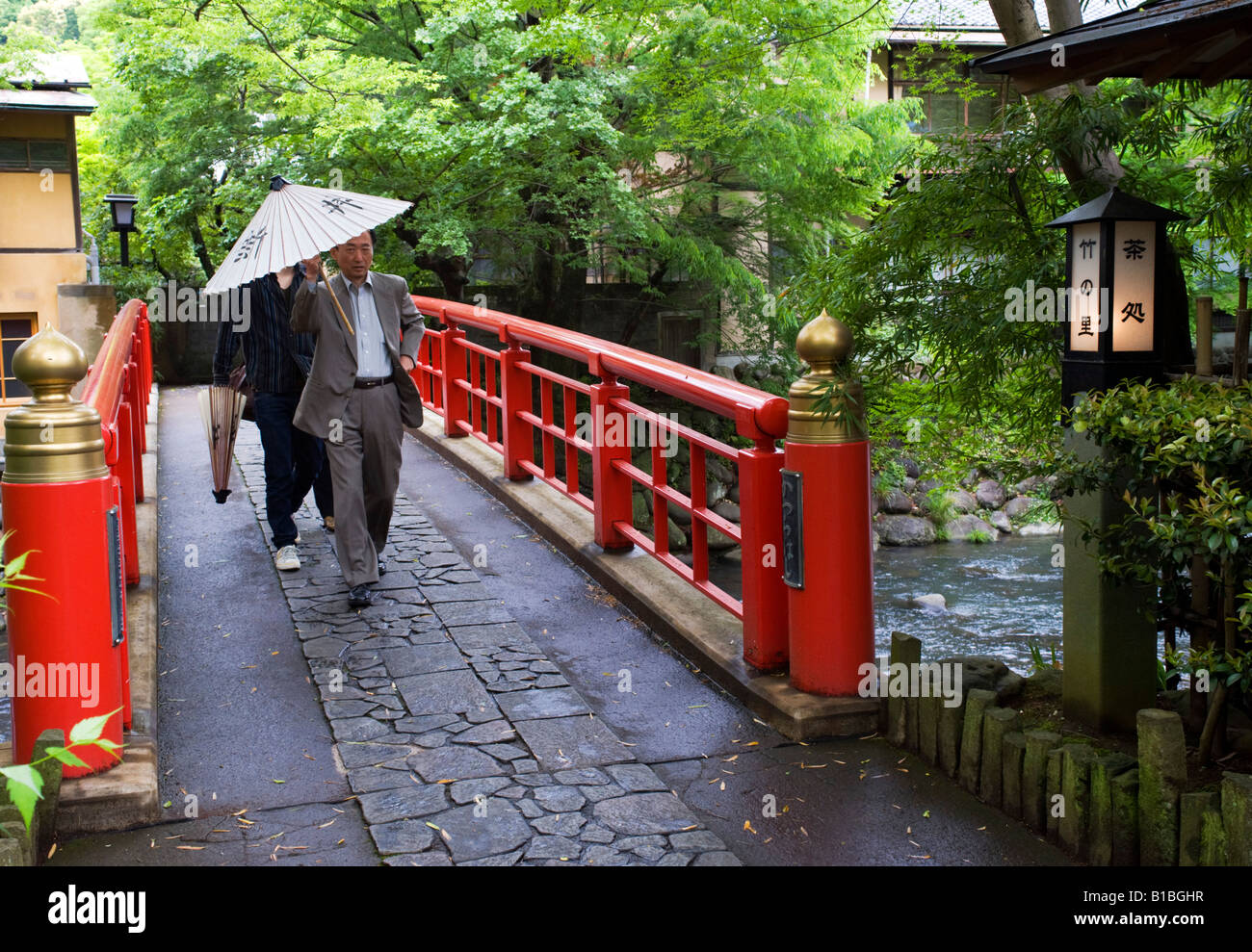 Small red wooden footbridge spanning river in Shuzenji in Izu Peninsula ...