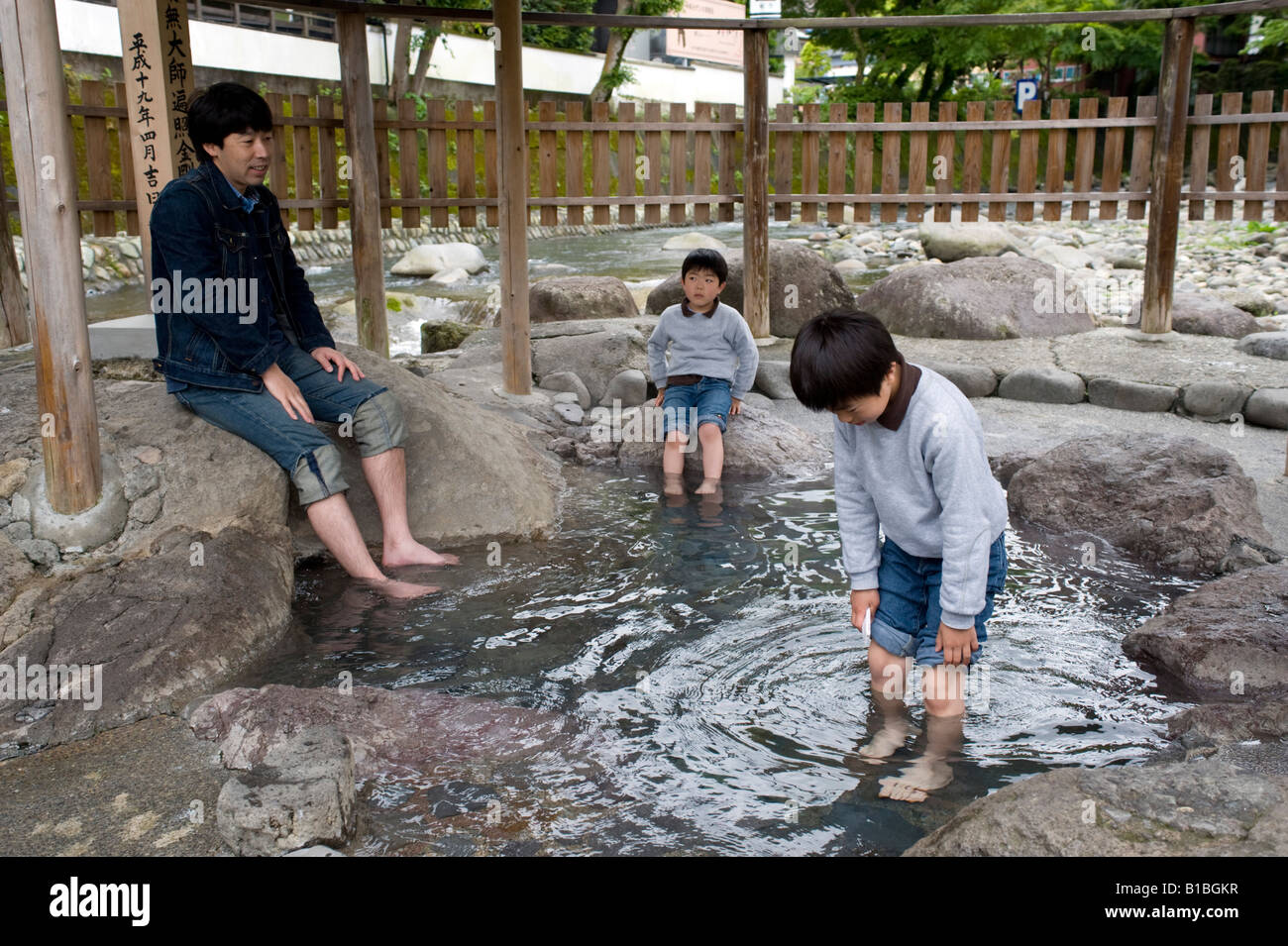 Family bathing feet in hot water outdoor onsen at Shuzenji in Izu ...