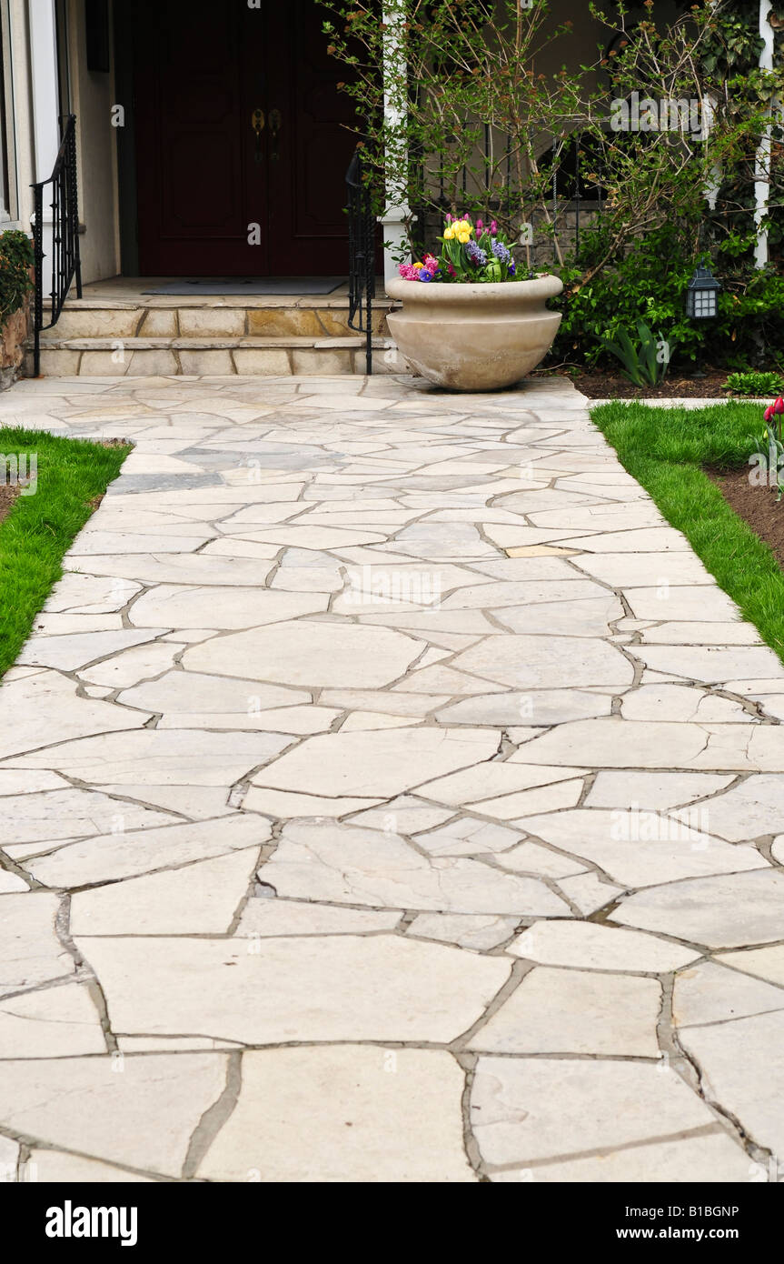 Natural stone path leading to a house landscaping element Stock Photo ...