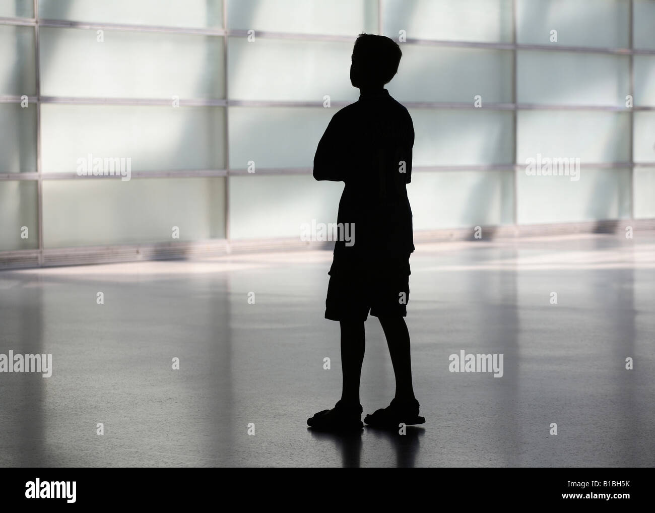 Silhouette of a boy folding his arms Stock Photo - Alamy