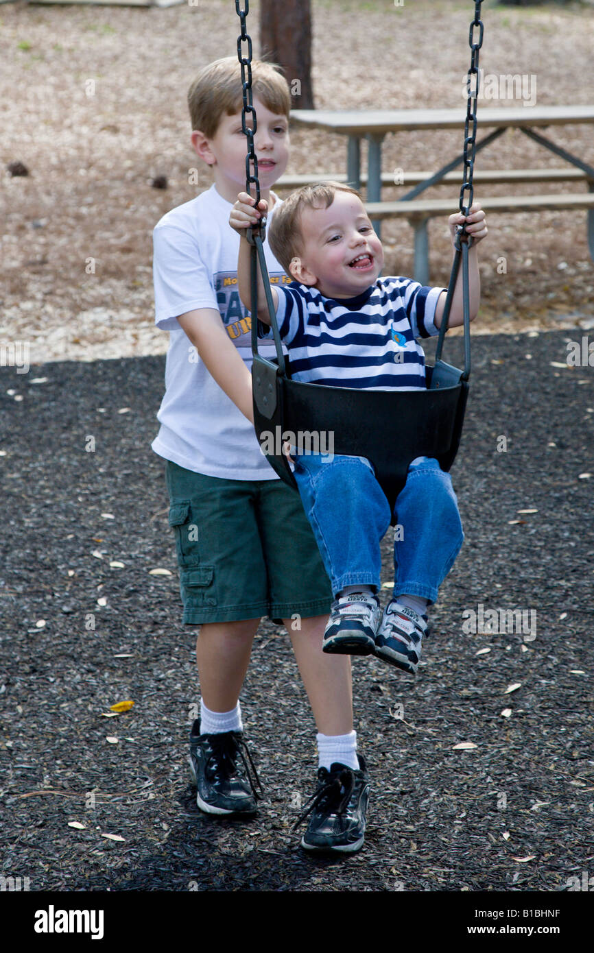 Brothers playing on playground equipment at Silver River State Park in ...