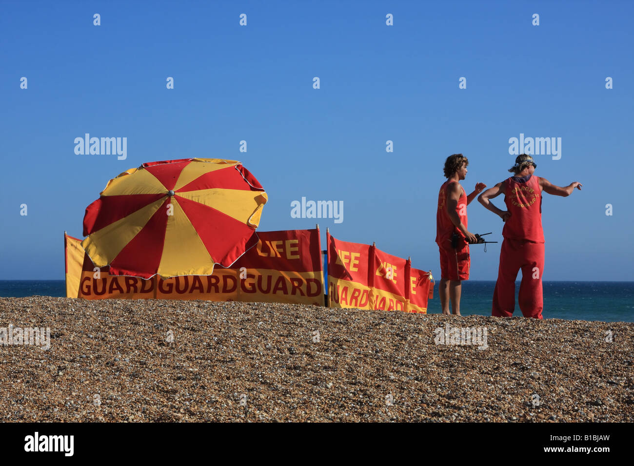 Two lifeguards pointing out to sea Stock Photo - Alamy