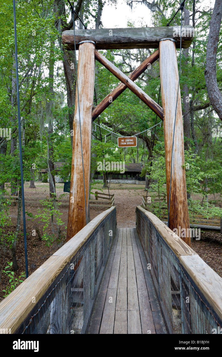 Wooden pedestrian suspension bridge over Santa Fe River on trail in O ...