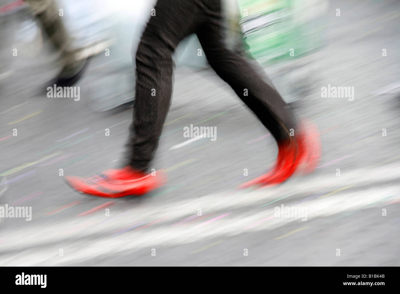 person with red shoes running in town Stock Photo - Alamy