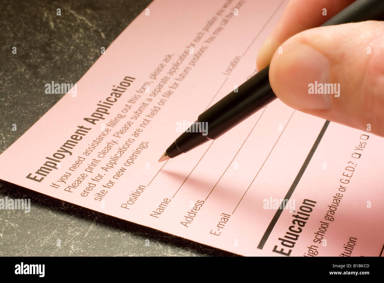 Man s hand filling out an employment application with a ballpoint pen ...