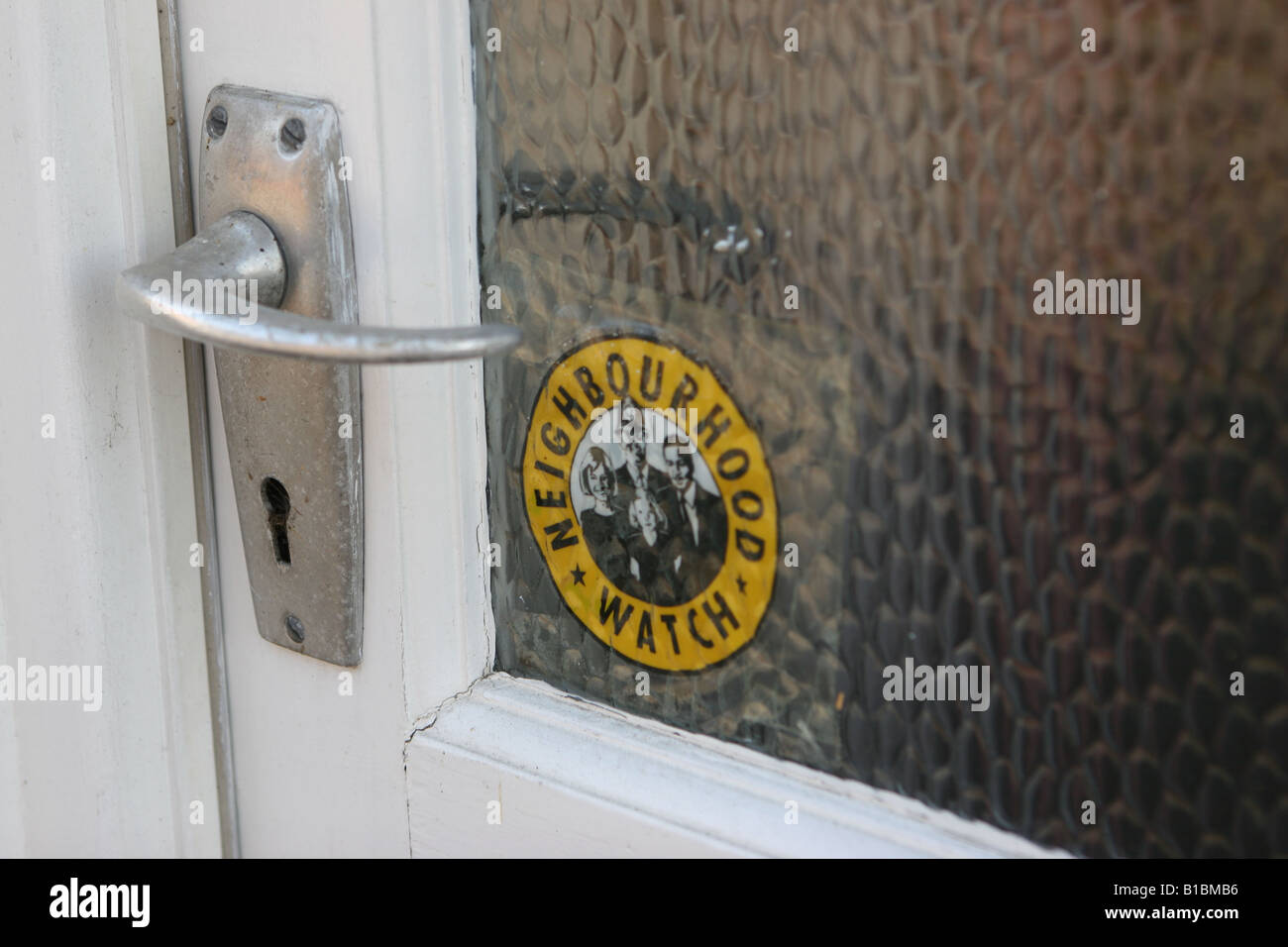 Neighbourhood watch sign on the glass window of a back door Stock Photo ...