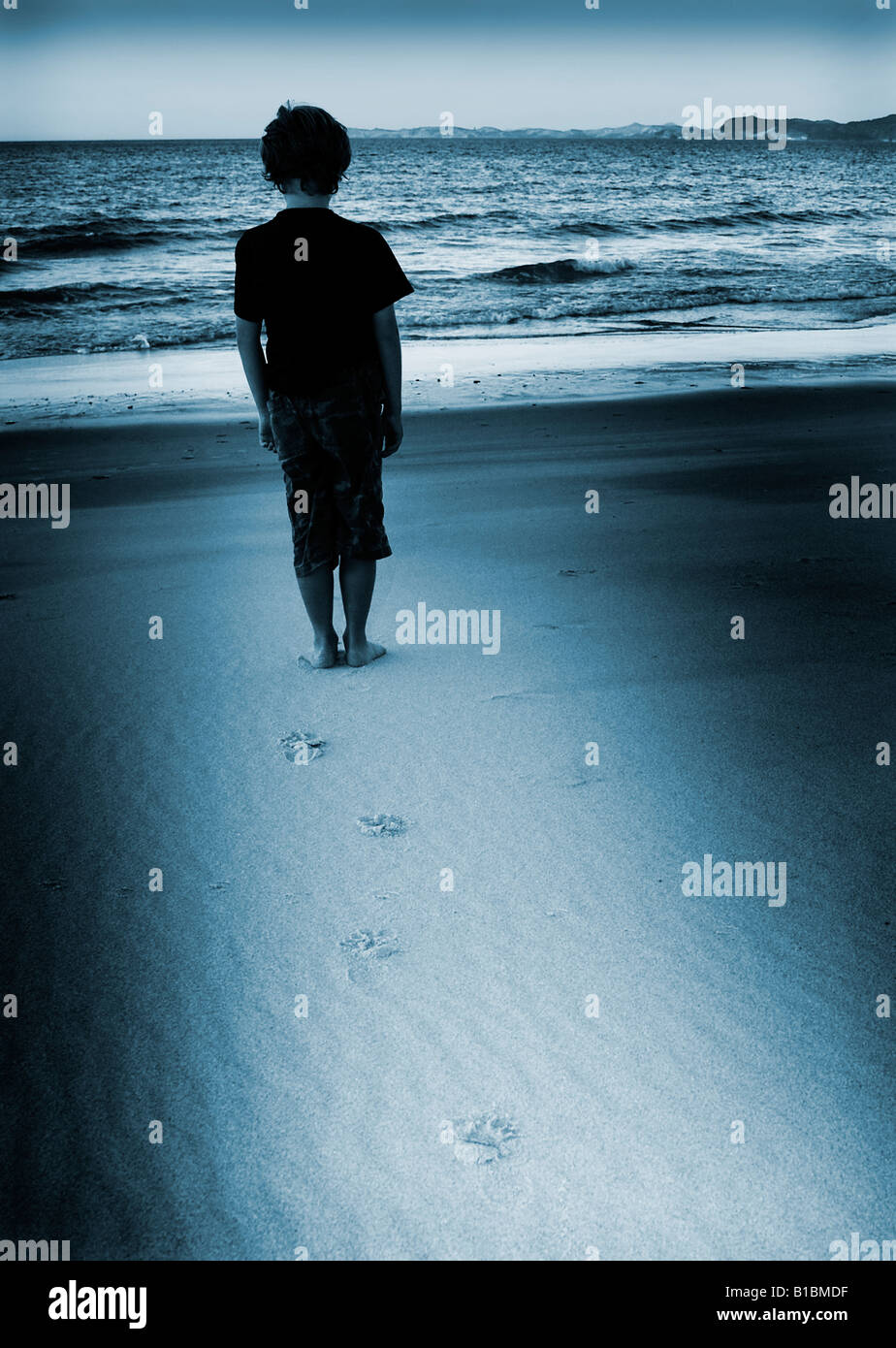 Boy standing sea watching waves hi-res stock photography and images - Alamy
