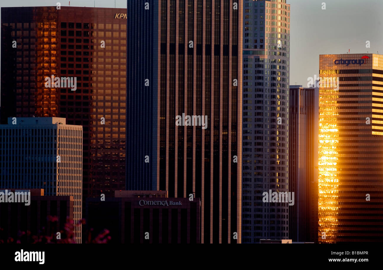Golden sunshine at sunset reflects off an office building in downtown ...