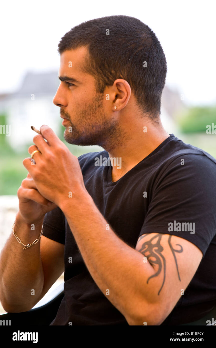Man Smoking a Cigarette Stock Photo - Alamy