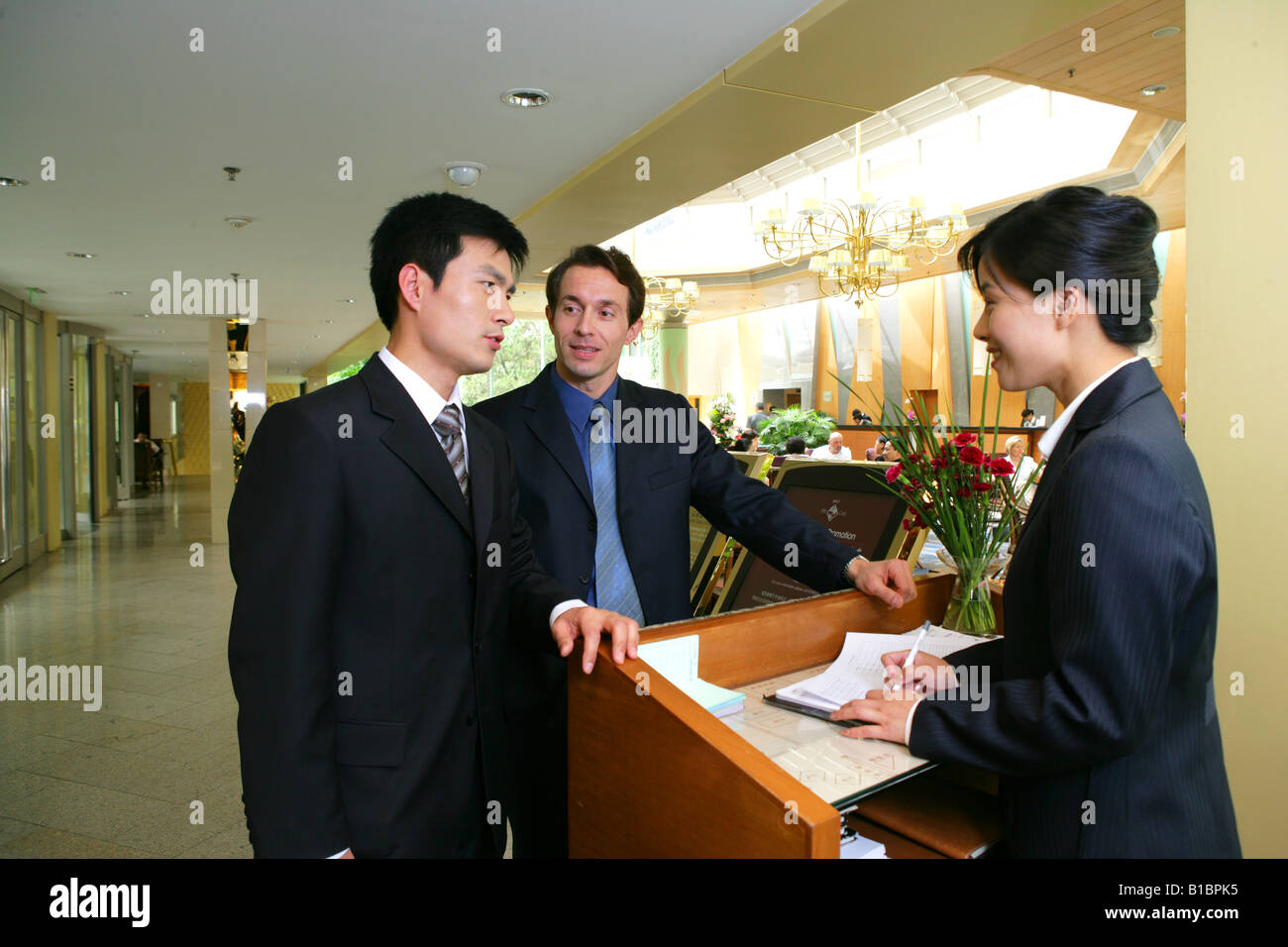 businessmen from different cultures talking with hotel manager Stock ...