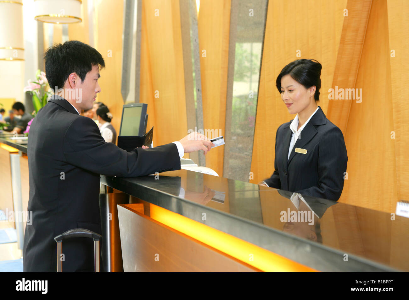 businessman using smart card at hotel reception Stock Photo - Alamy
